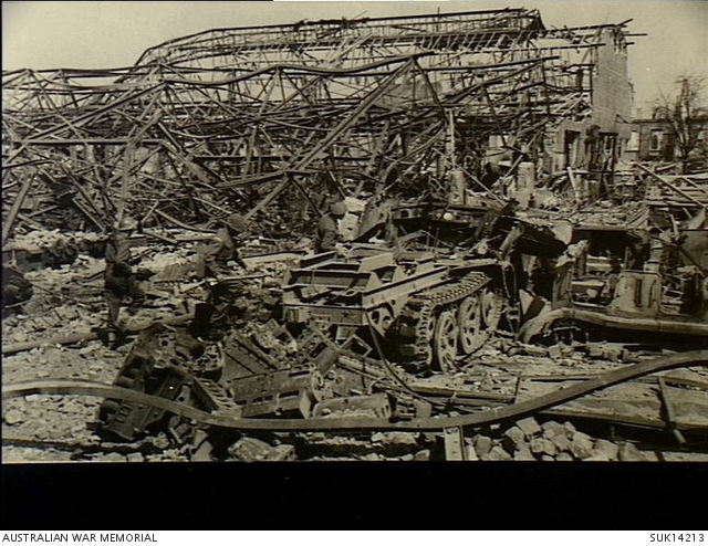 Bremen, Germany. 1945-04-26. Soldiers walk through rubble past a ...