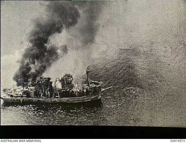 Gulf of Siam, Thailand. 1945-08. This burning tug is the result of an ...