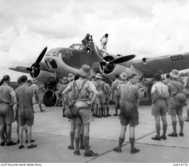 Singapore. C. 1945-11. Locally based RAAF personnel greet the arrival ...