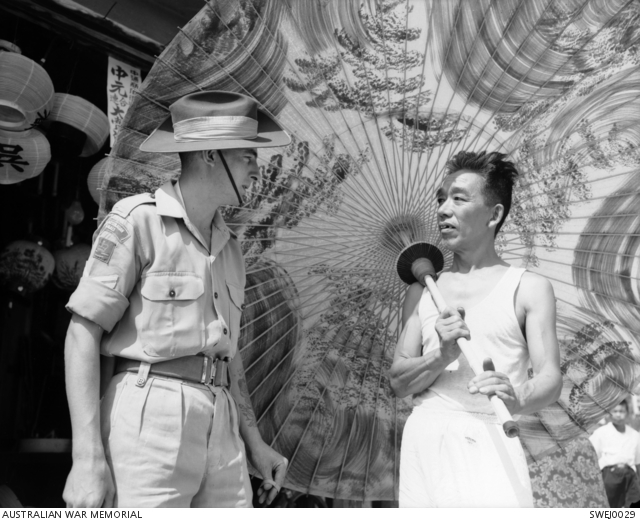 Shopping for souvenirs in Kure, Japan, is Corporal (Cpl) Nev Woods, of ...
