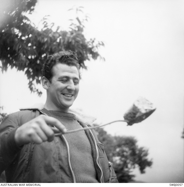 Private Ron Bell, of East Melbourne, Vic, cooks with Headquarters ...