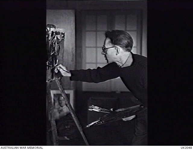 CAPTAIN COLIN COLAHAN, AN AUSTRALIAN WAR ARTIST, BUSY ON A PICTURE OF ...