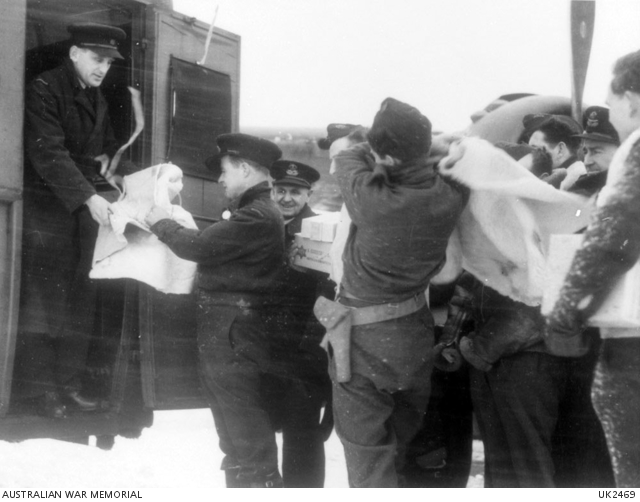 Mr Syd Stevens (in doorway) issuing Australian Comfort Fund parcels to ...