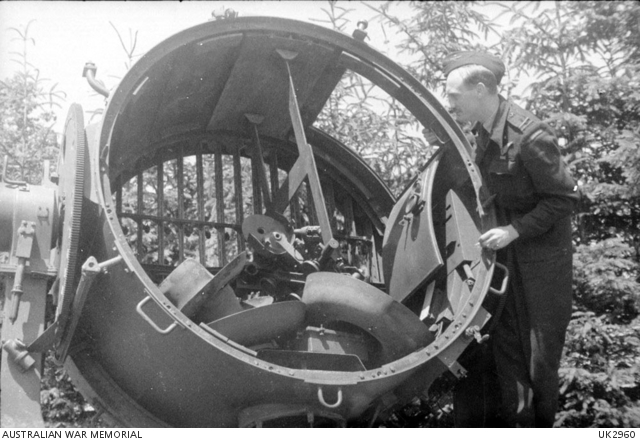 Germany. C. 1945-06. Flight Lieutenant John Hall DFC, RAAF, examining a ...