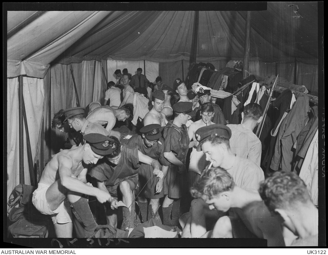 England. 1945-08-04. RAAF airmen dressing in the "dressing room" while ...