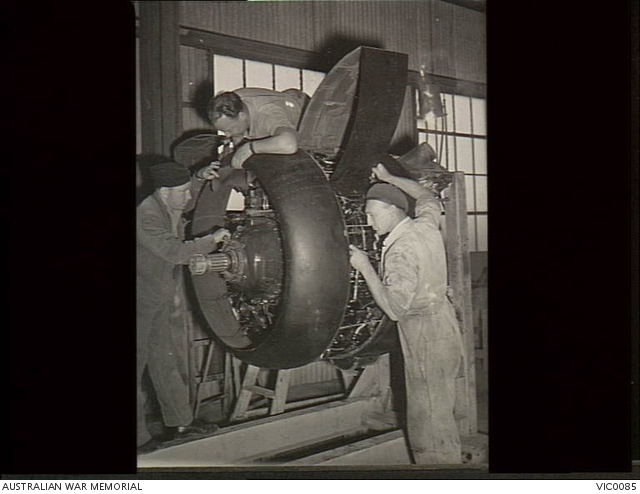 Maintenance personnel working on an engine from a flying boat at No. 1 ...