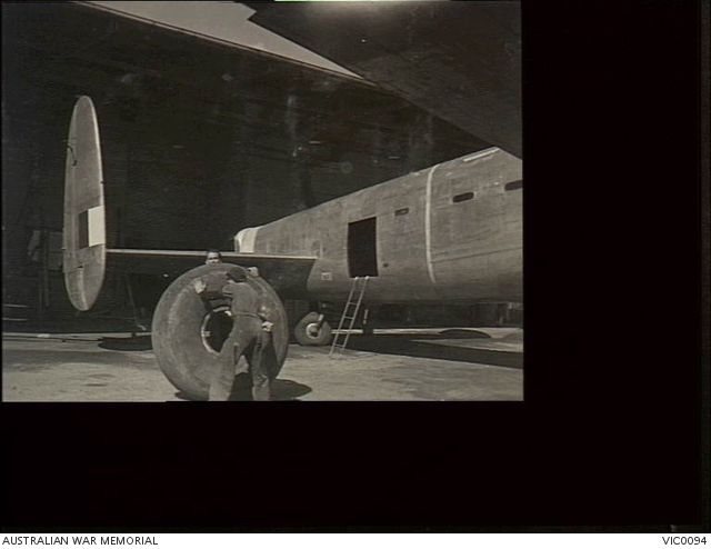 Sale, Vic. C. 1944. Maintenance personnel man-handling a wheel from ...