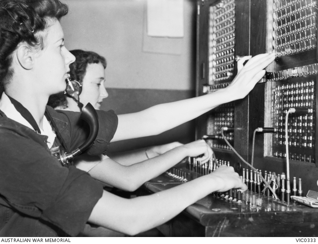 Point Cook, Vic. C. 1942. Two WAAAF telephonists at work at a busy ...