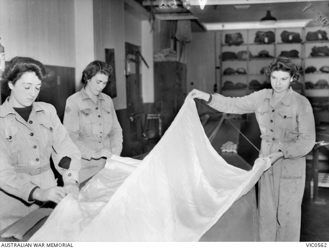 Point Cook, Vic. C. 1945-03. Three WAAAF fabric workers folding a ...