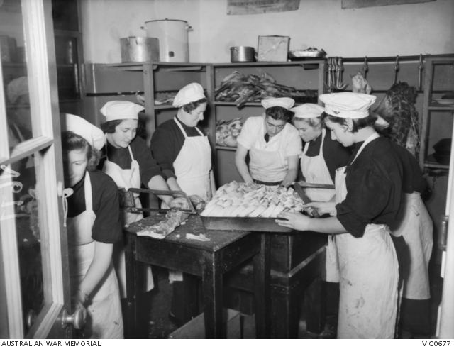 West Melbourne, Vic. 1942-10-20. A RAAF cook (centre) explaining ...