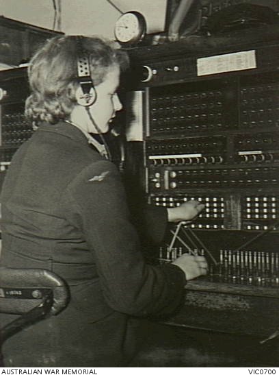 A WAAAF telephonist at work on a telephone switchboard at a RAAF unit ...