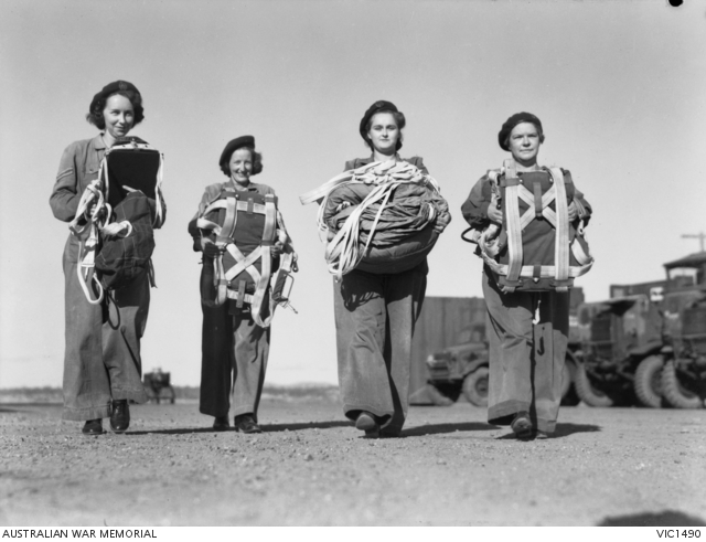 Amberley, Qld. C. 1943. Four WAAAF fabric workers carrying parachutes ...