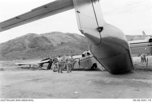 Several unidentified men from the No 35 Squadron, RAAF, stand around ...