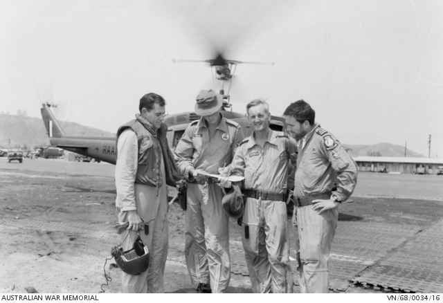 Lining up to sign a picture of a No 9 Squadron, RAAF, Iroquois ...