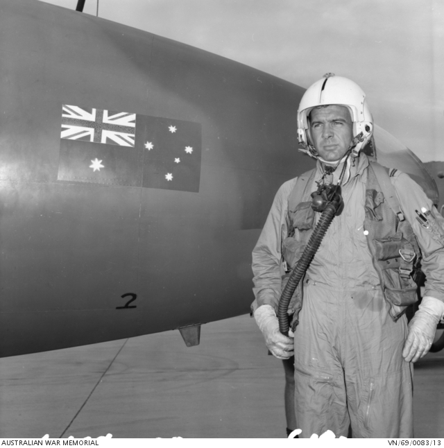 An unidentified crew member standing in front of the nose section of a ...